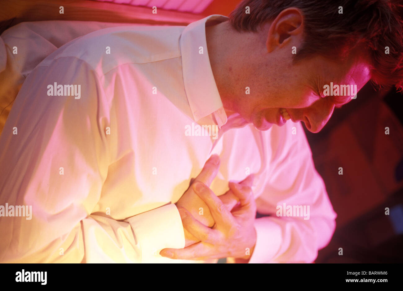 Man clutch chest holding hi-res stock photography and images - Alamy