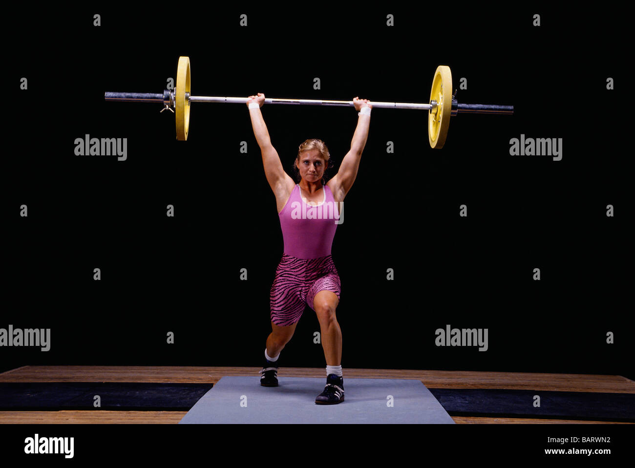 Female Olympic style weightlifter in action Stock Photo - Alamy