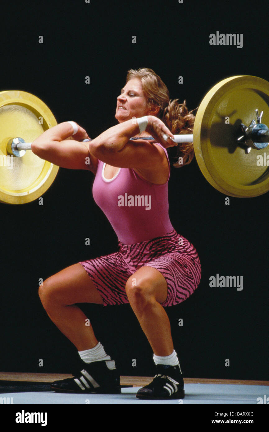 Female Olympic style weightlifter in action Stock Photo - Alamy