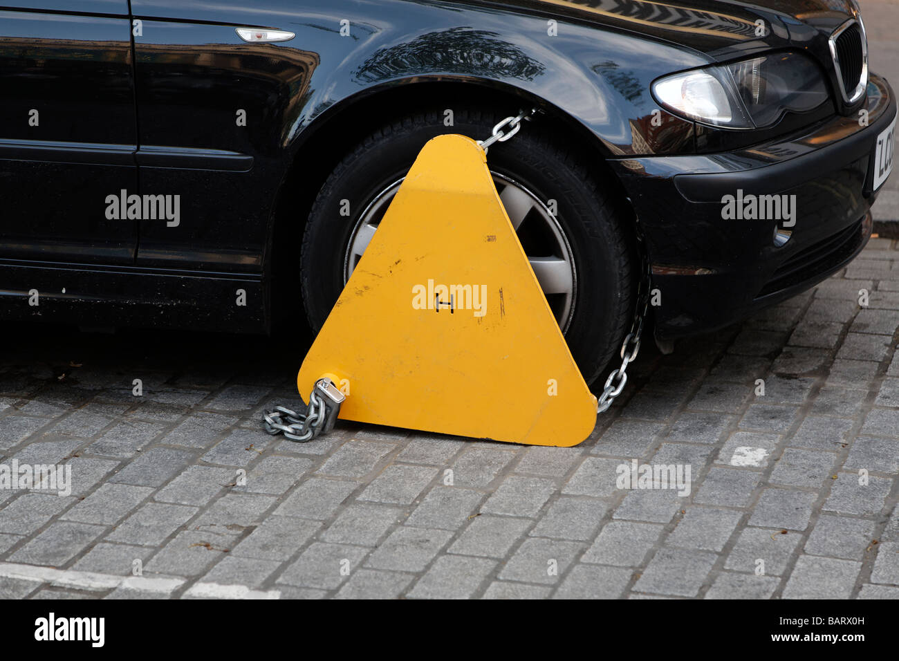 Wheel clamped car Stock Photo - Alamy