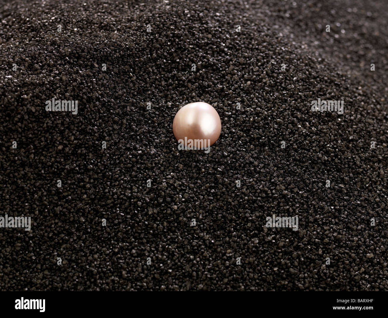 Pearl on black sand Stock Photo - Alamy