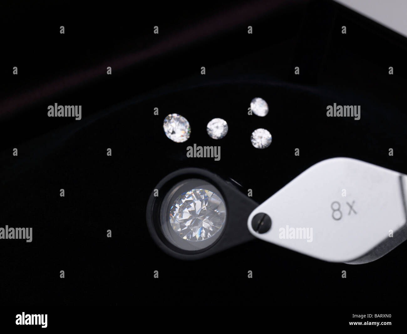 Magnifying glass over diamond Stock Photo - Alamy