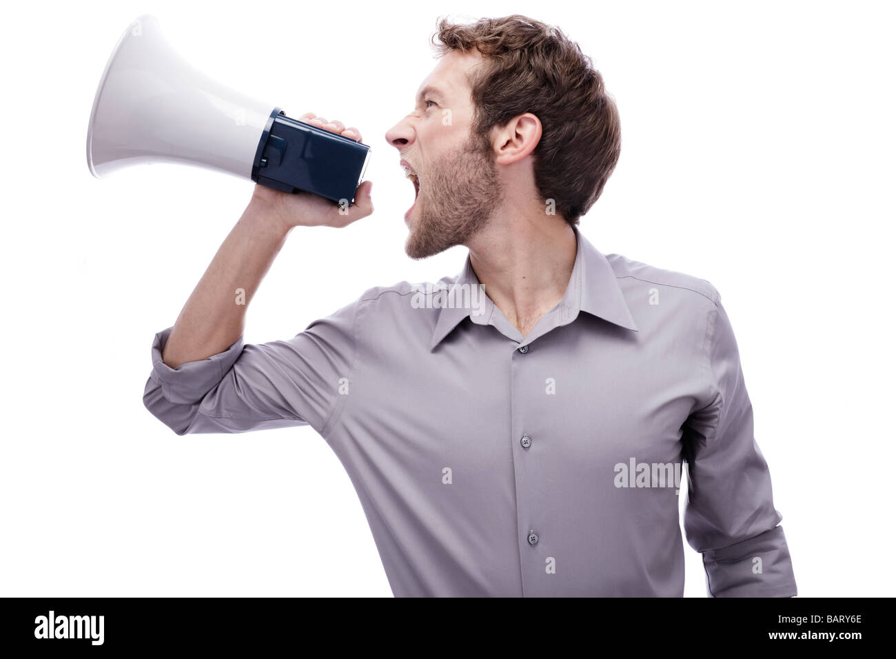 Young man holding megaphone, portrait Stock Photo - Alamy
