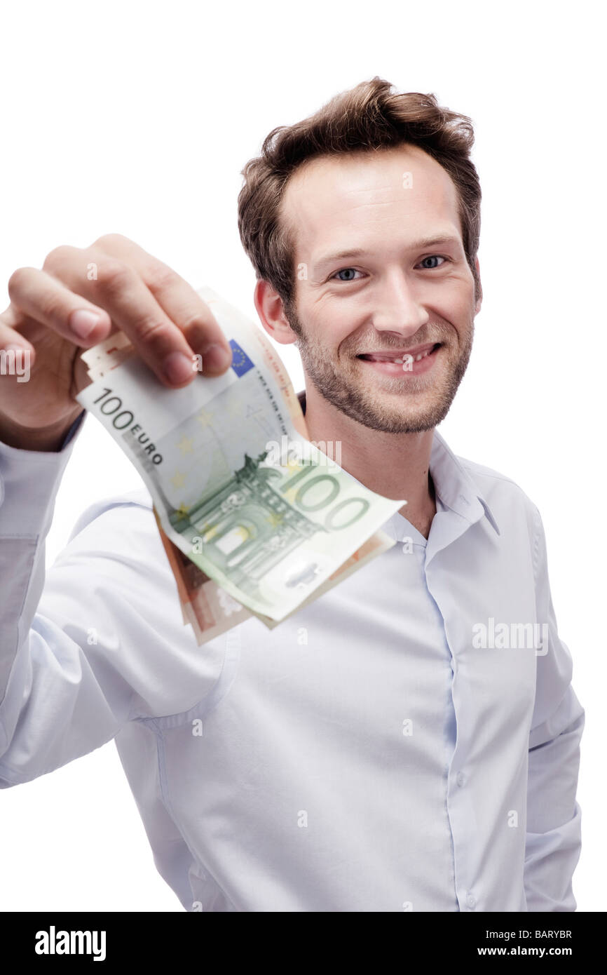 Young man holding Euro notes, portrait Stock Photo - Alamy