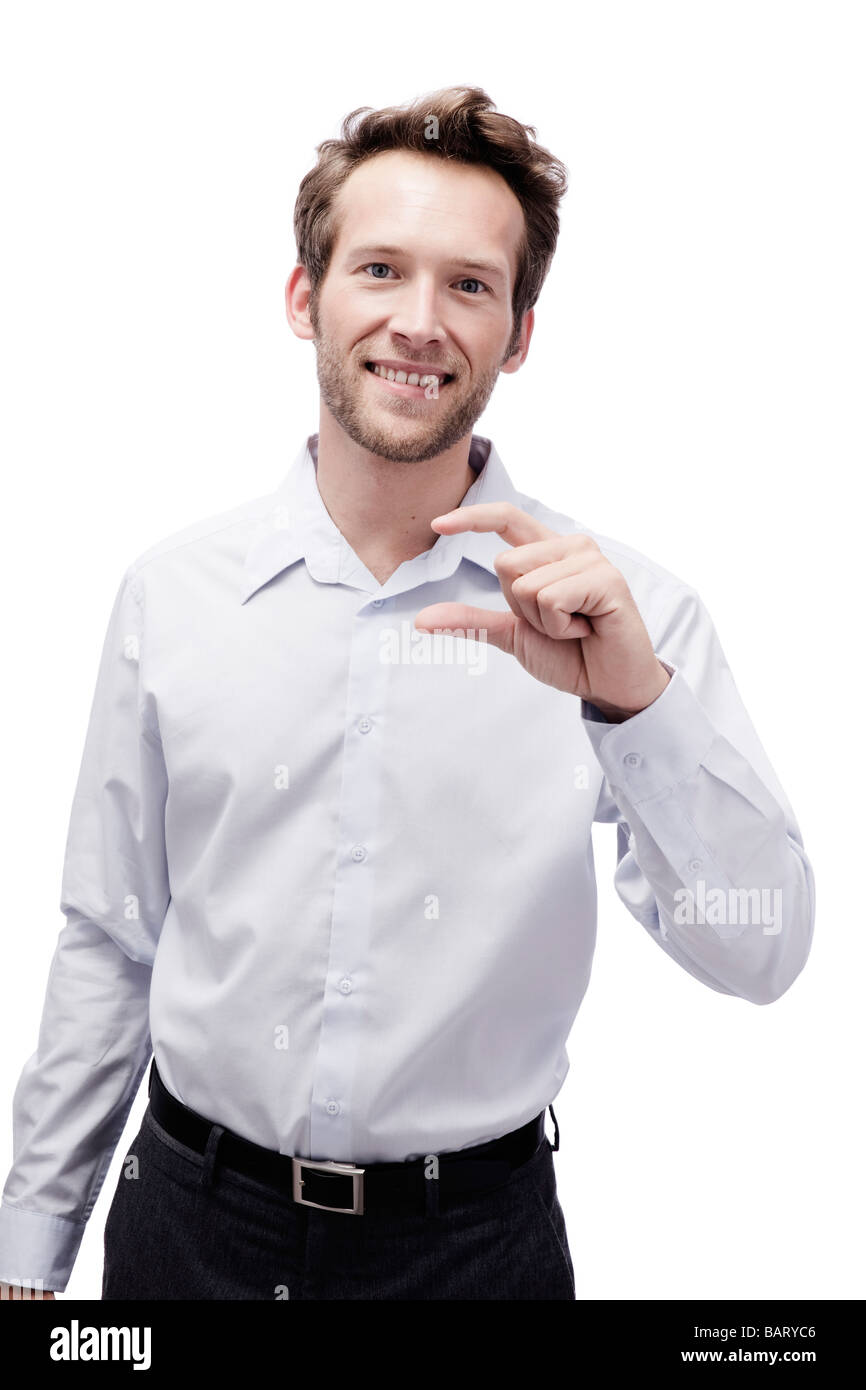 Young man making hand gesture, smiling, portrait Stock Photo - Alamy
