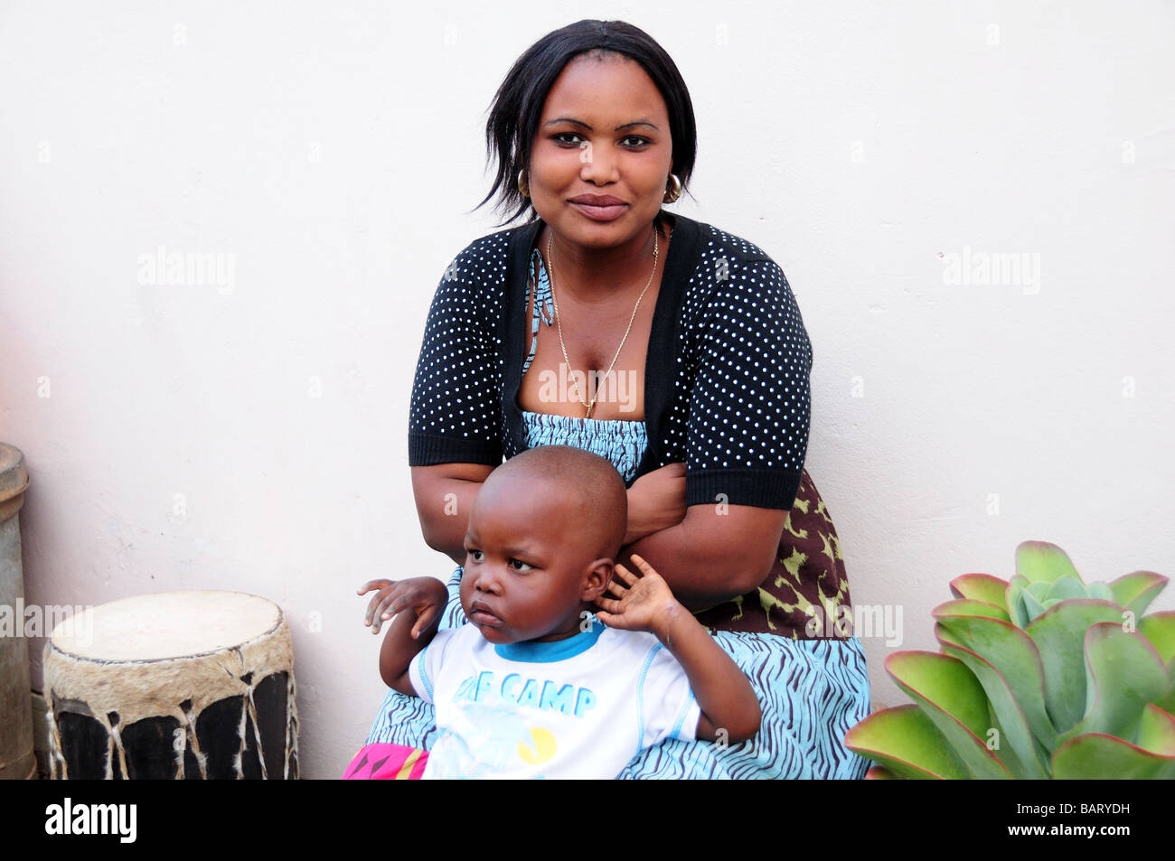 Portrait of a smiling African mother and baby boy in a Township ...