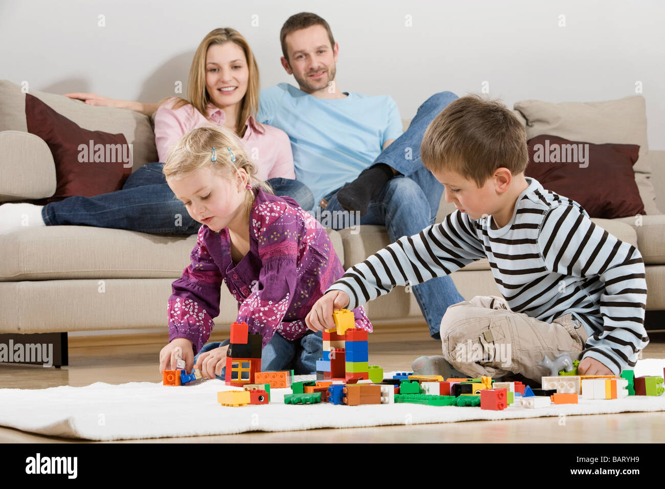 Family at home, children playing with building bricks Stock Photo - Alamy