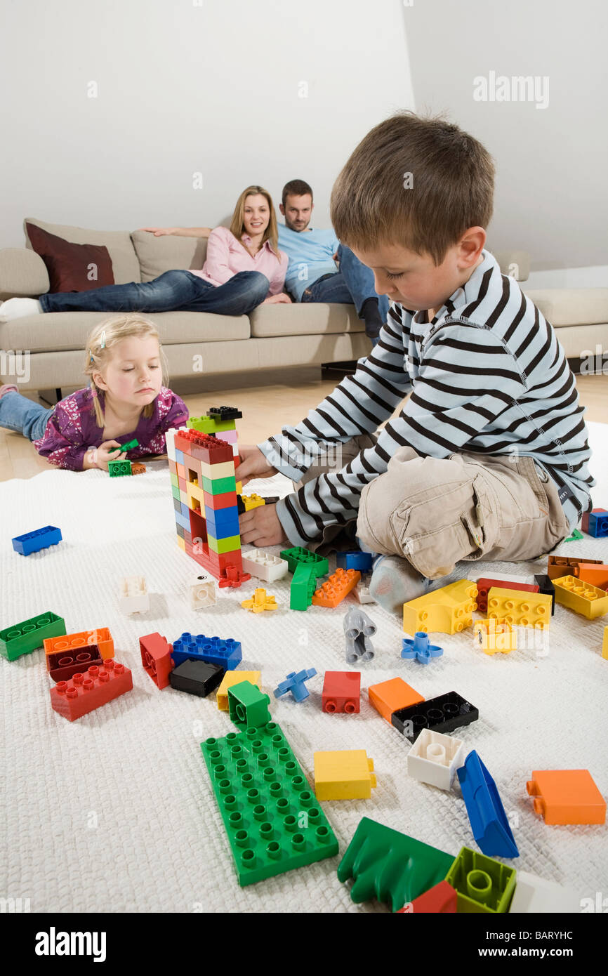 Family relaxing at home, children playing with building bricks Stock ...