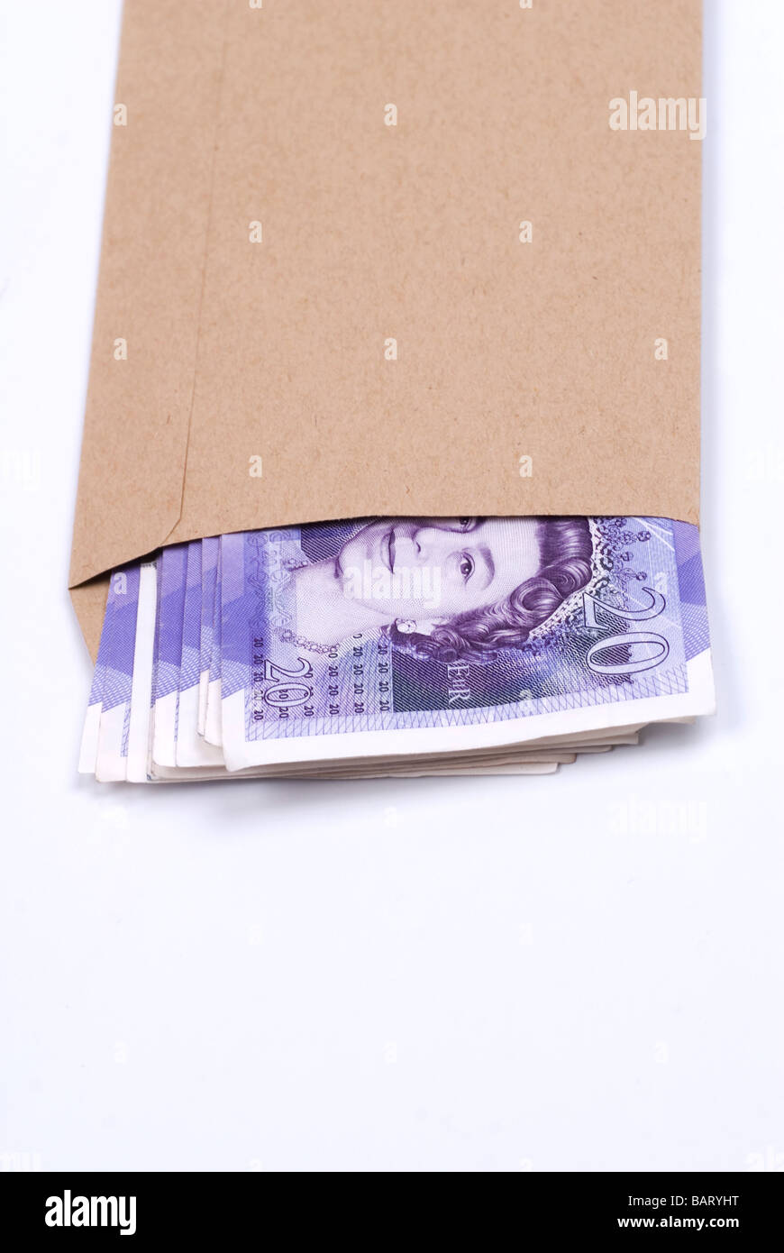 Stack of British money inside a brown envelope against a white ...