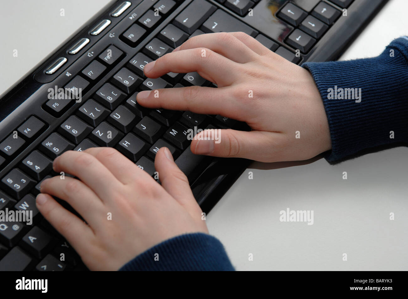 Boy's hand using keypad of PC, elevated view Stock Photo - Alamy