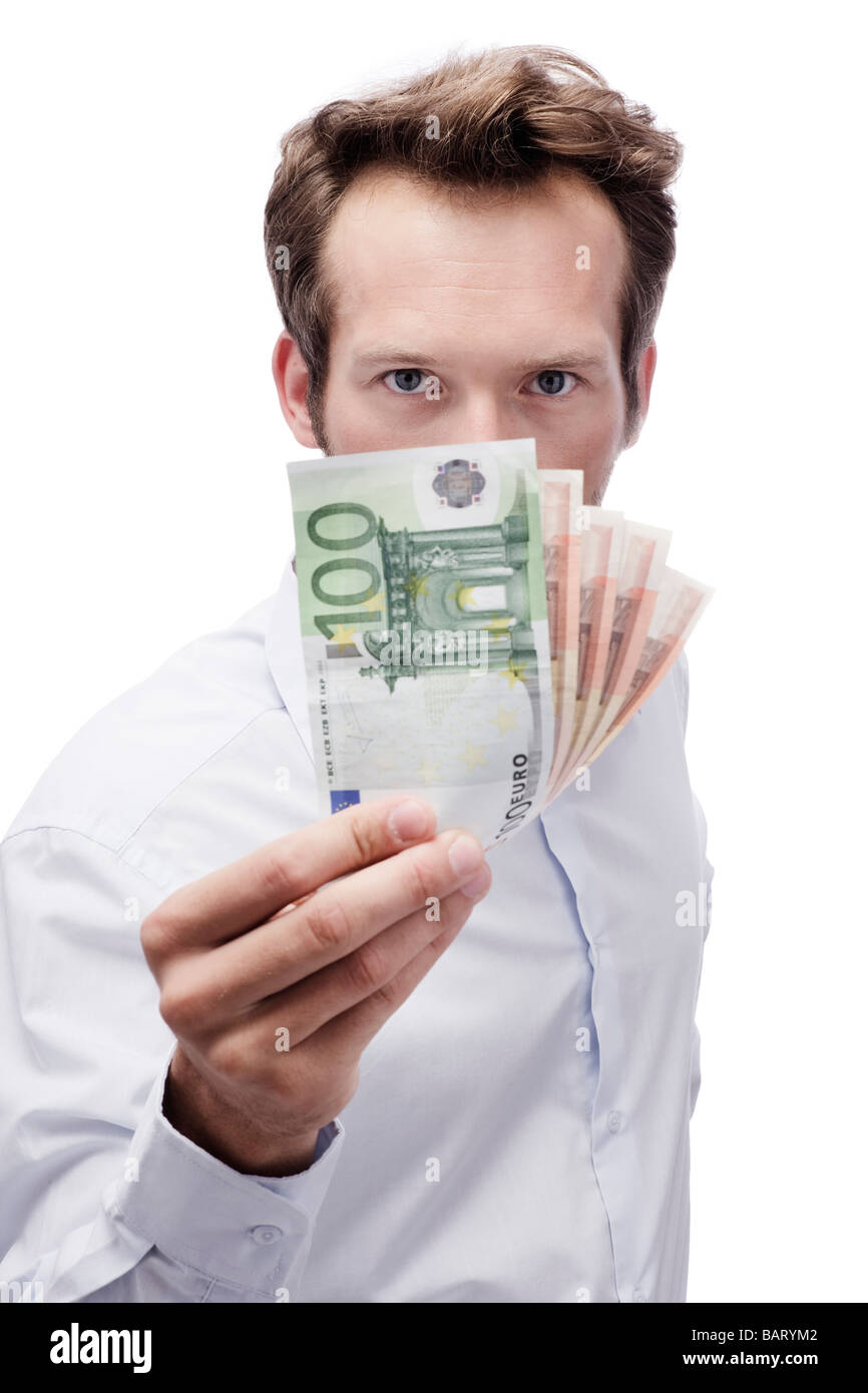 Young man holding Euro notes, portrait Stock Photo - Alamy