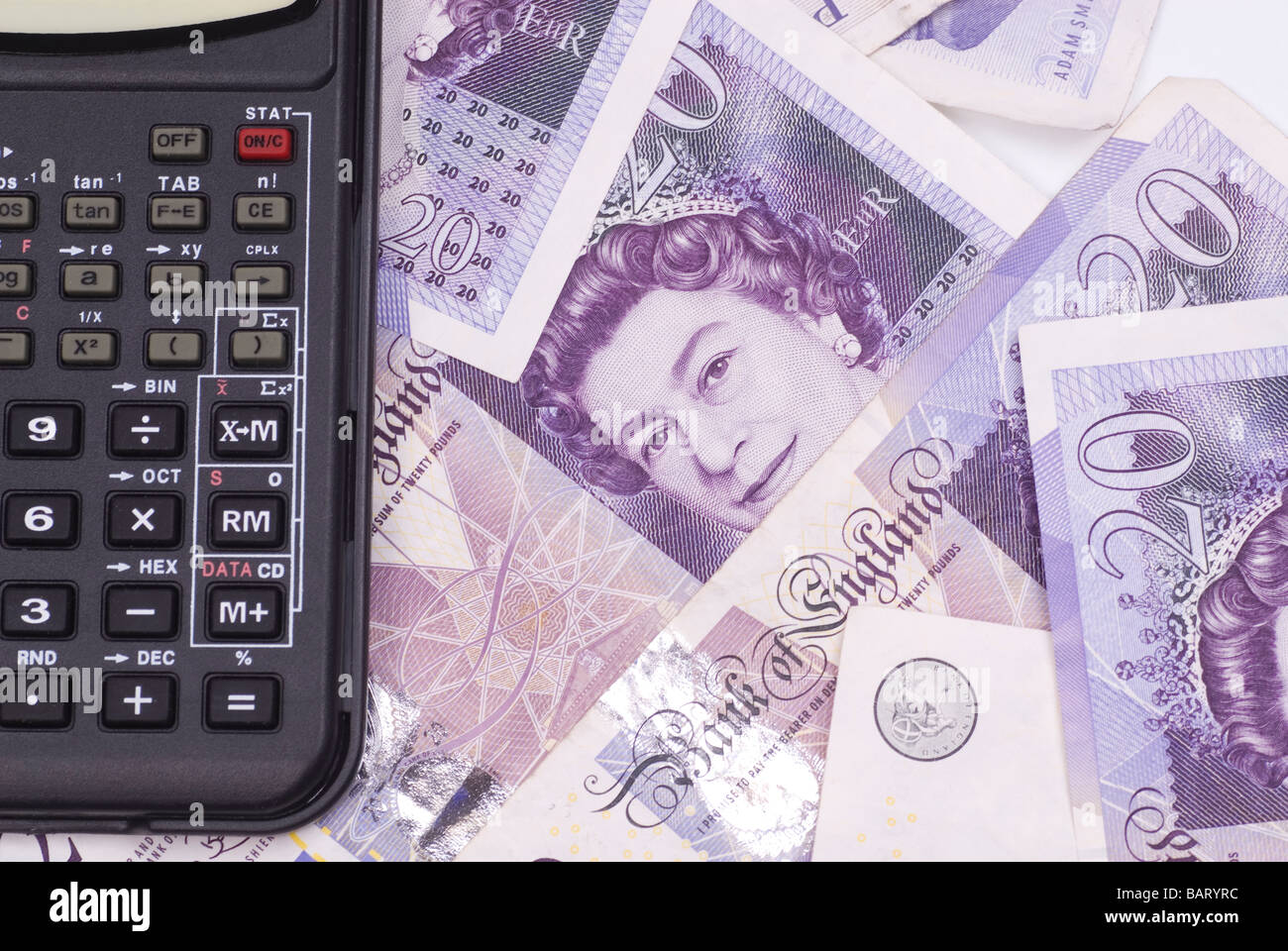 Calculator of a pile of British money Stock Photo - Alamy