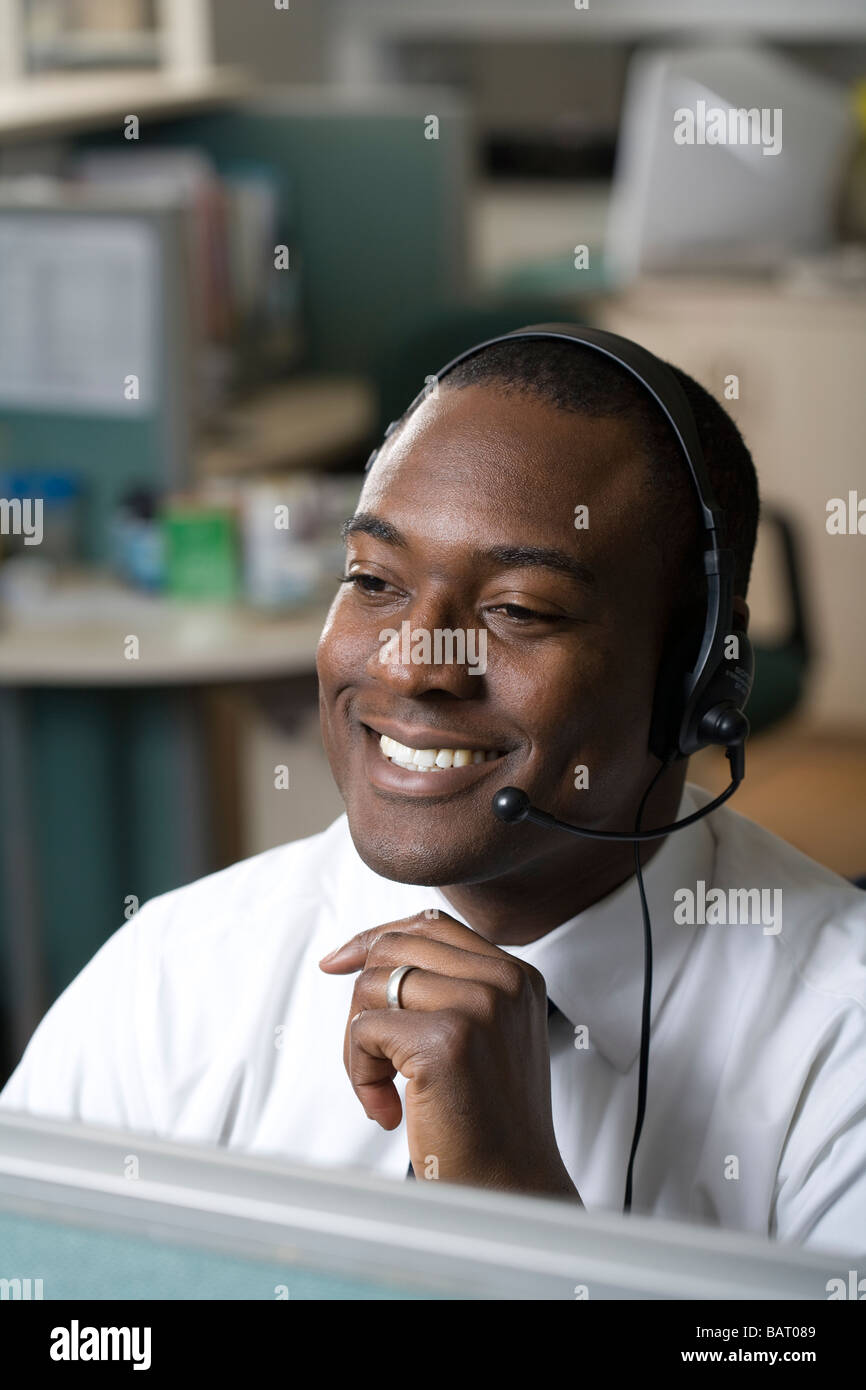 Businessman talking on headset Stock Photo - Alamy