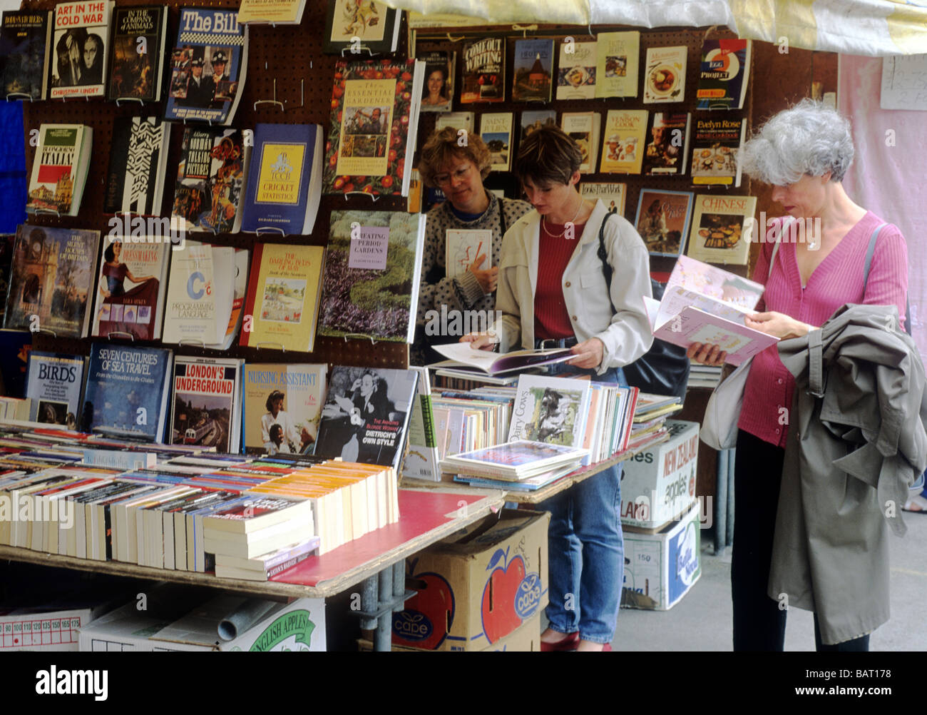 Cambridge market book stall customers browsing books reading readers ...
