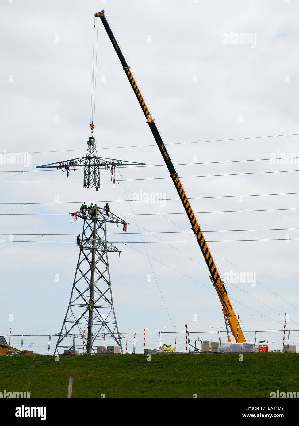 Erection of electricity tower using crane and high level workforce in Derbyshire Stock Photo - Alamy