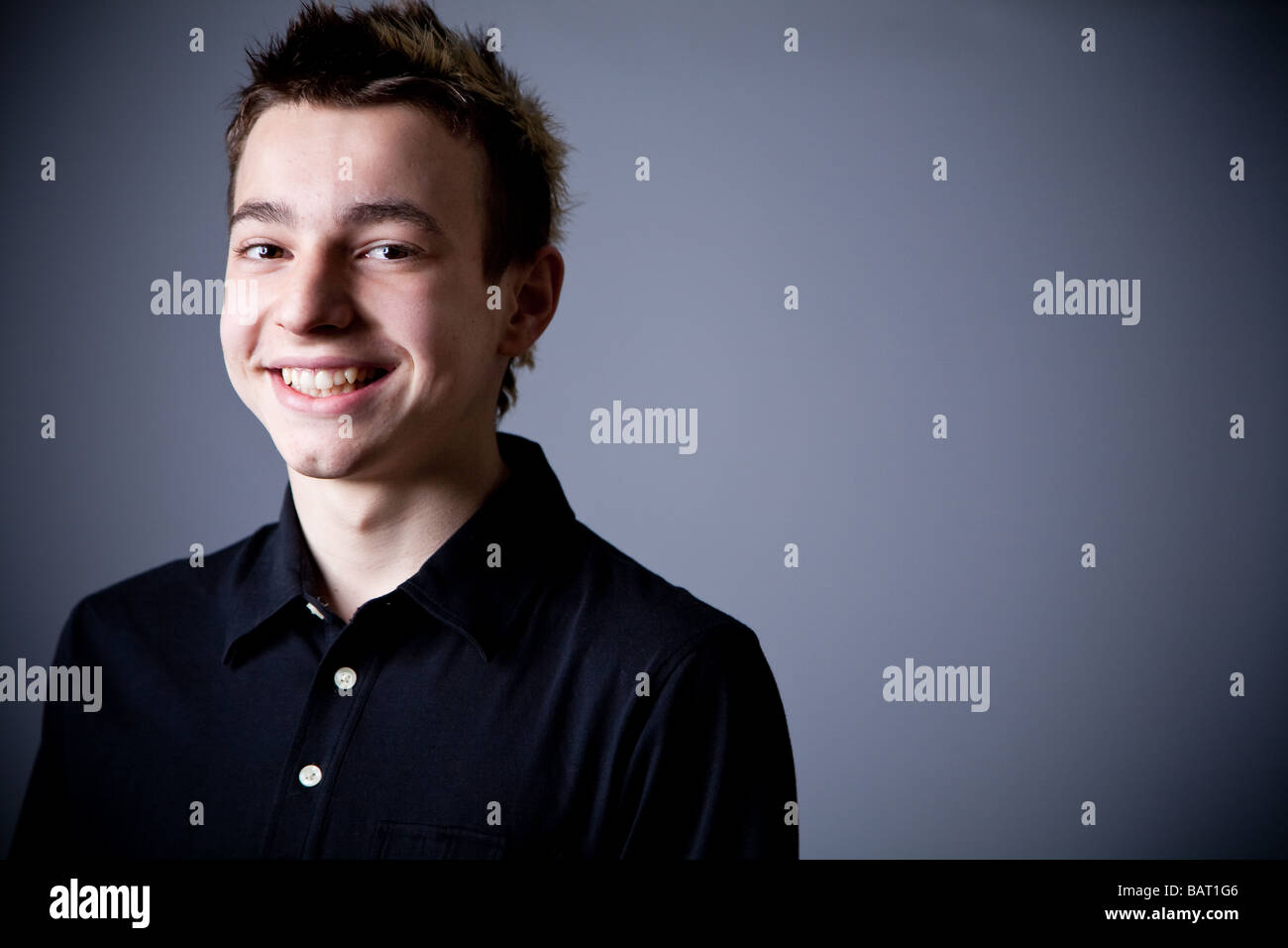 Portrait of teenage boy on a grey background Stock Photo - Alamy