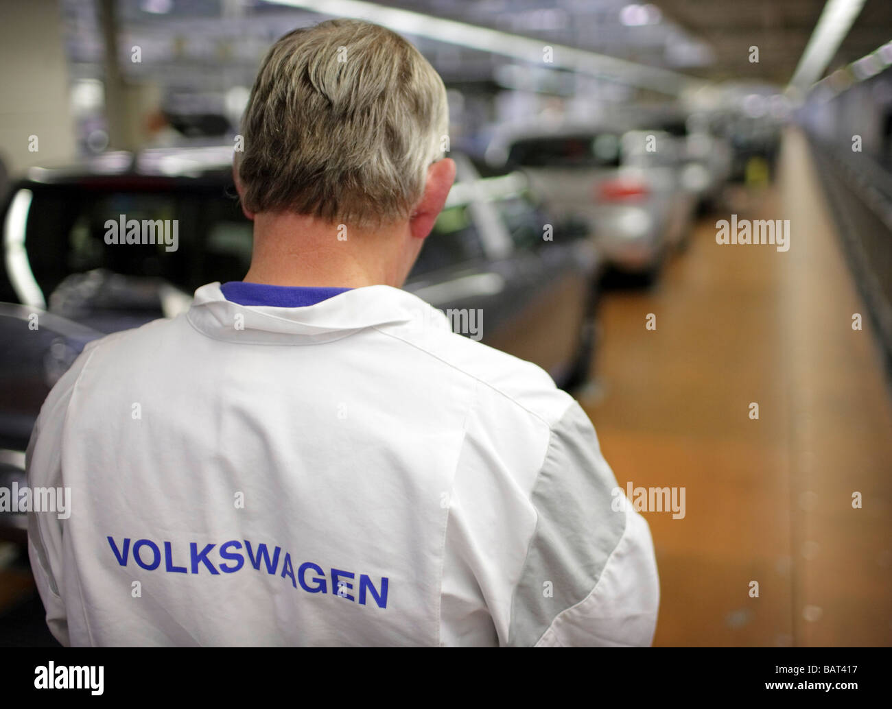Worker at the assembly line of the VW Golf at Auto 5000 GmbH Volkswagen ...
