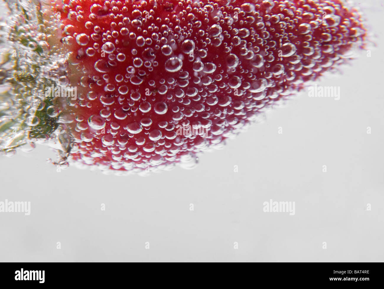 Strawberry in water with bubbles Stock Photo - Alamy