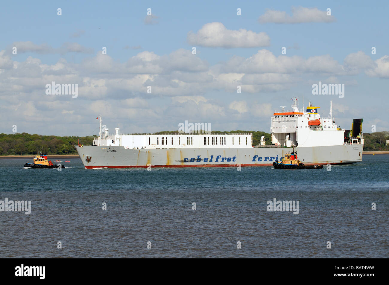 RoRo freighter ship Undine underway on Southampton Water with tugs in ...