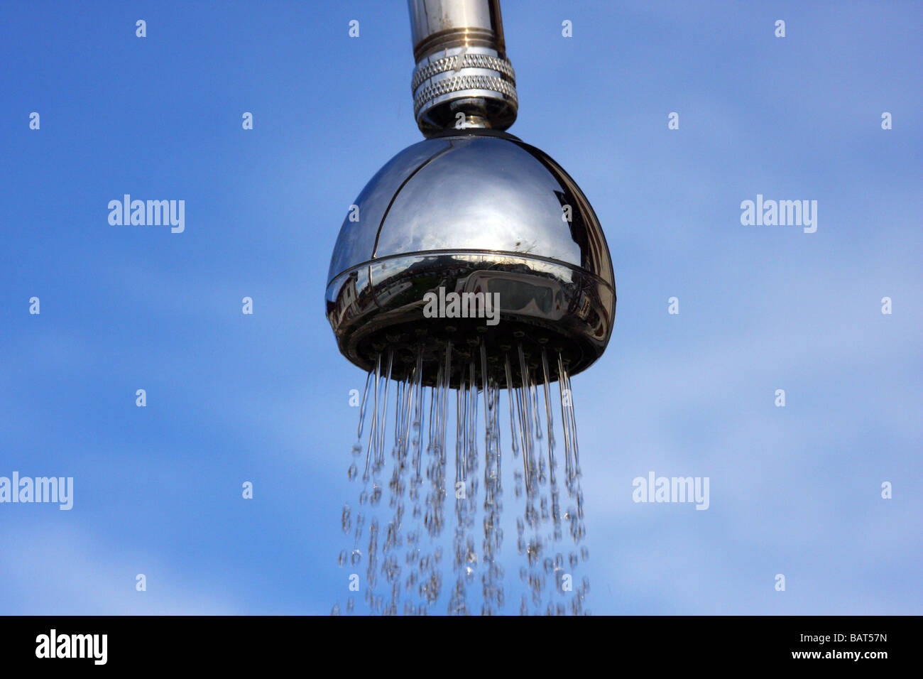 Chrome shower head by an outdoor swimming pool with flowing water Stock ...