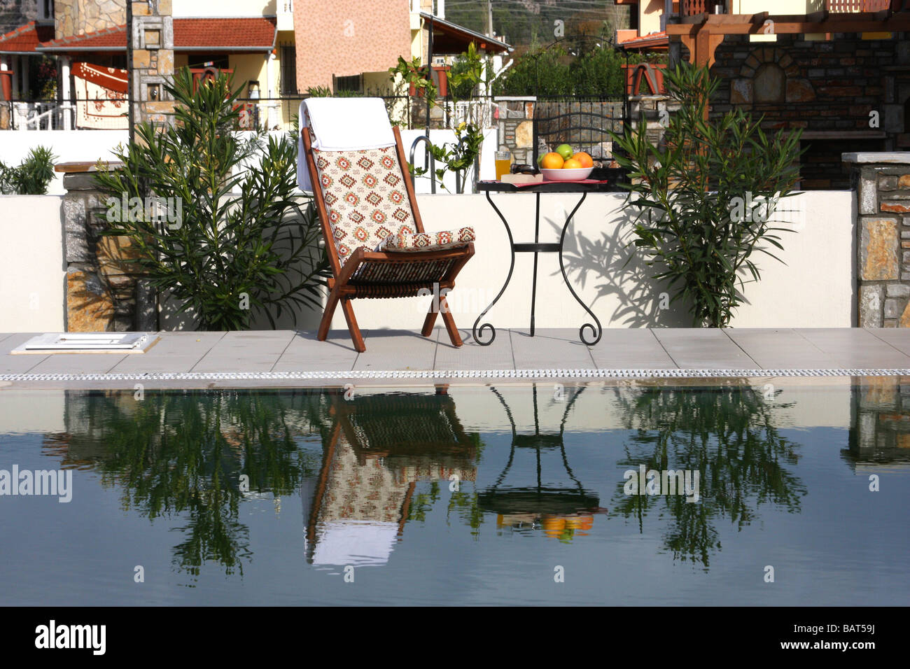 A relaxing chair by the swimming pool Stock Photo - Alamy