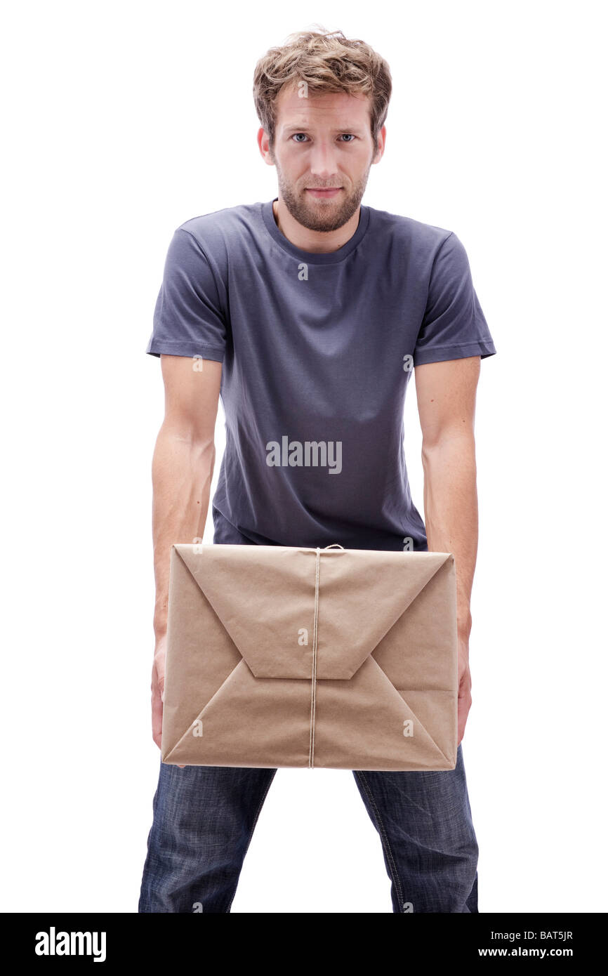 Young man holding packet, portrait Stock Photo - Alamy