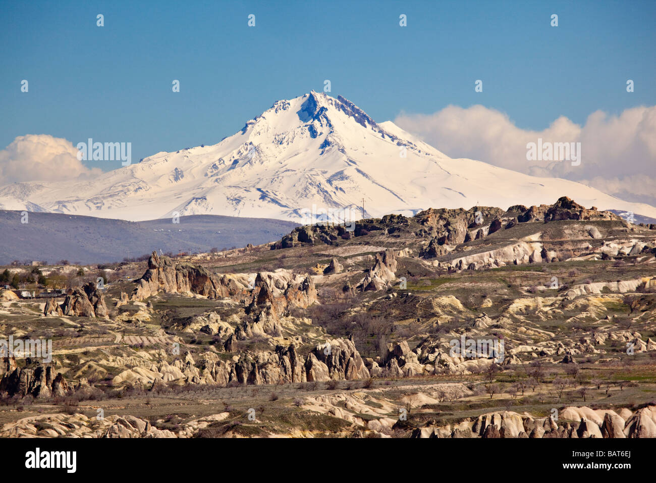 Rock formations and snow covered volcano in Cappadocia Turkey Stock ...