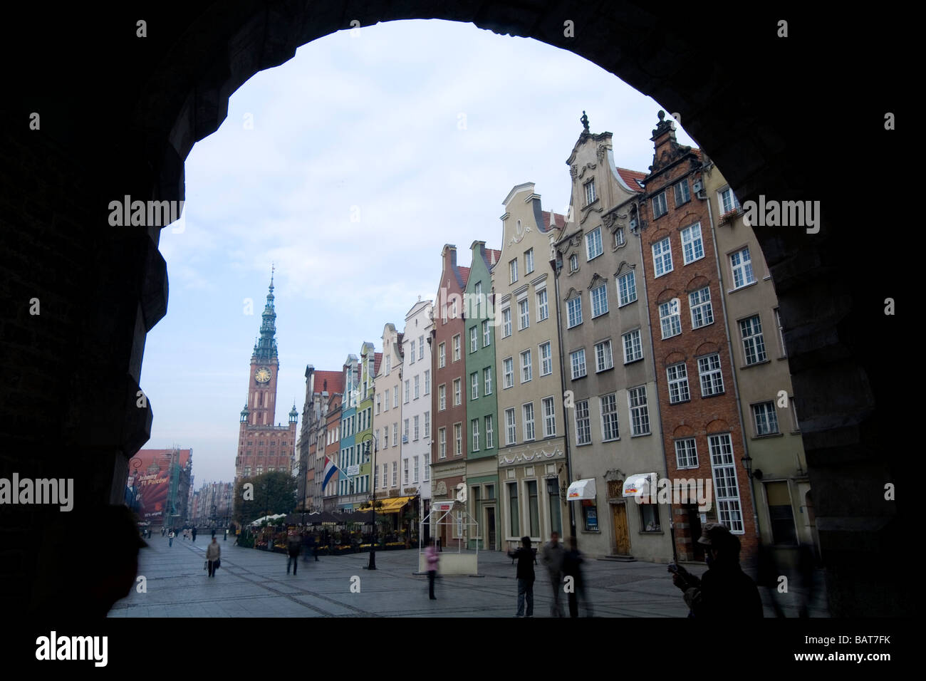 View under an arch with buildings on street Stock Photo - Alamy