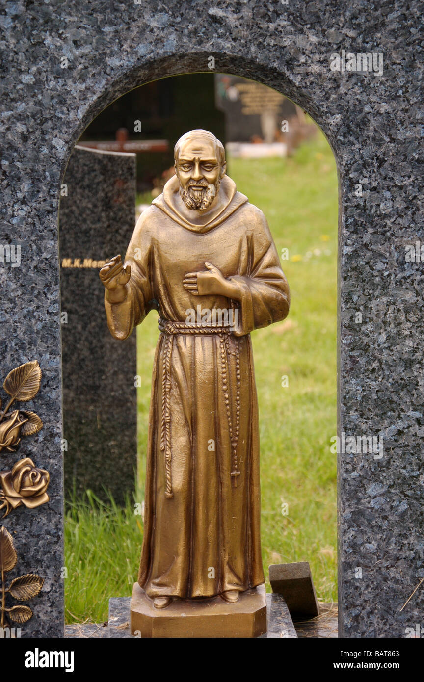 Statue of a priest on a headstone in Islington cemetery, London ...