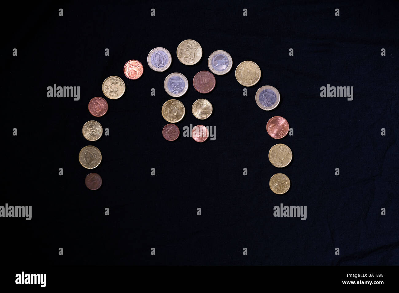 Euro sign made up of coins on black Stock Photo - Alamy