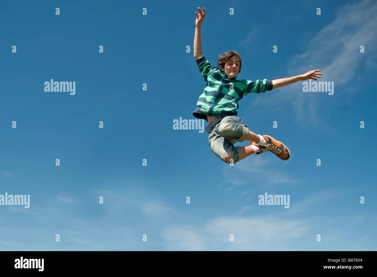 Teenage boy jumping high into the sky Stock Photo - Alamy