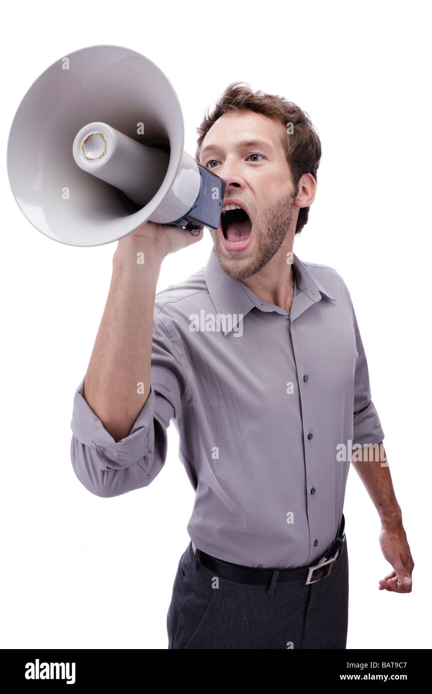 Young man holding megaphone, portrait Stock Photo - Alamy