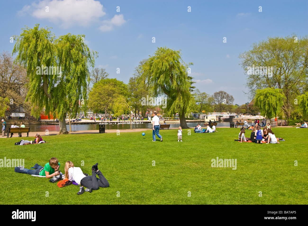 Horizontal wide angle of people relaxing and enjoying the sunny weather ...