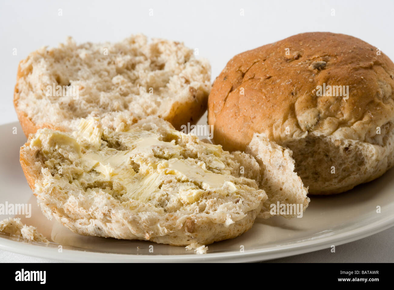 Two bread rolls one buttered Stock Photo - Alamy