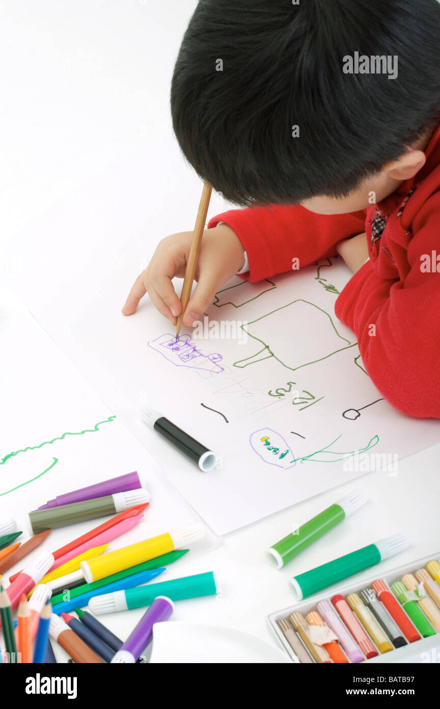 Boy drawing on paper Stock Photo - Alamy