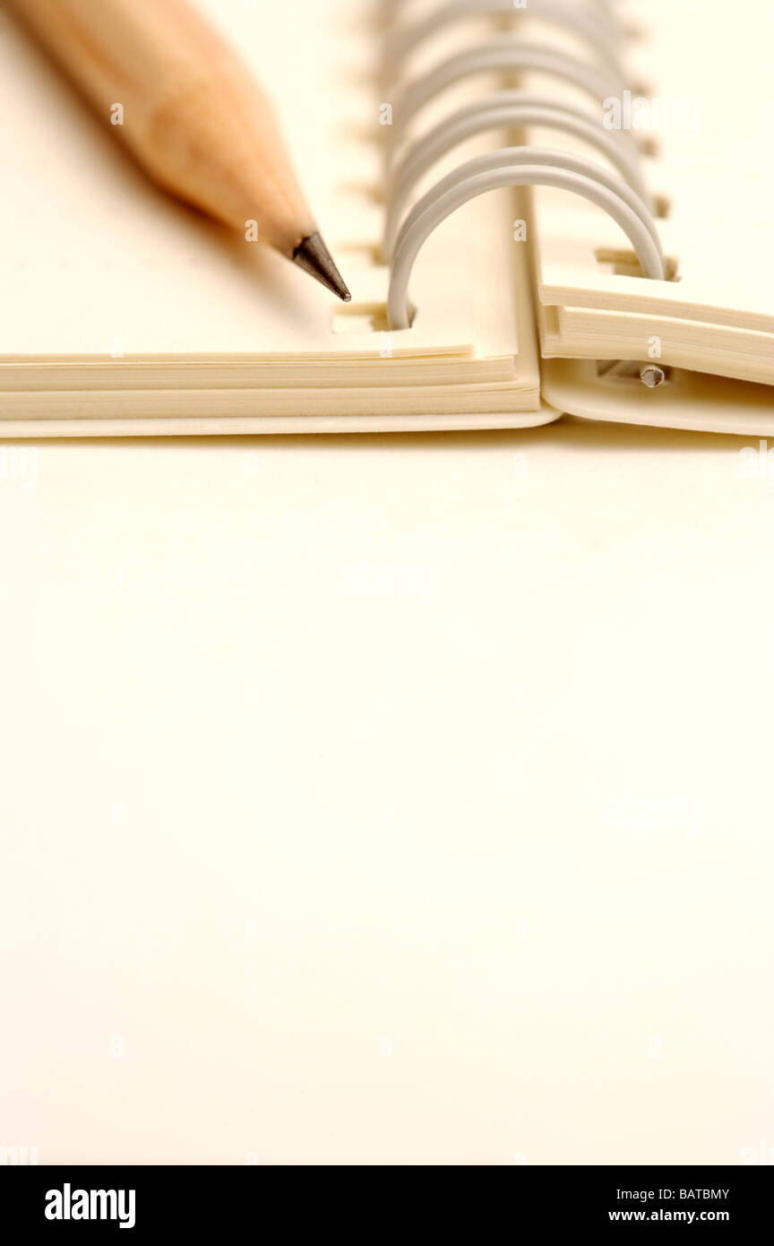 Spiral notebook and pencil Stock Photo - Alamy