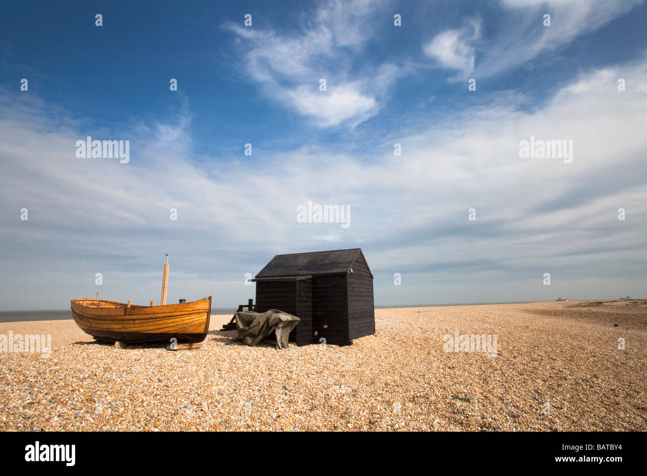 Traditional clinker built fishing boat and weatherboard hut on a ...