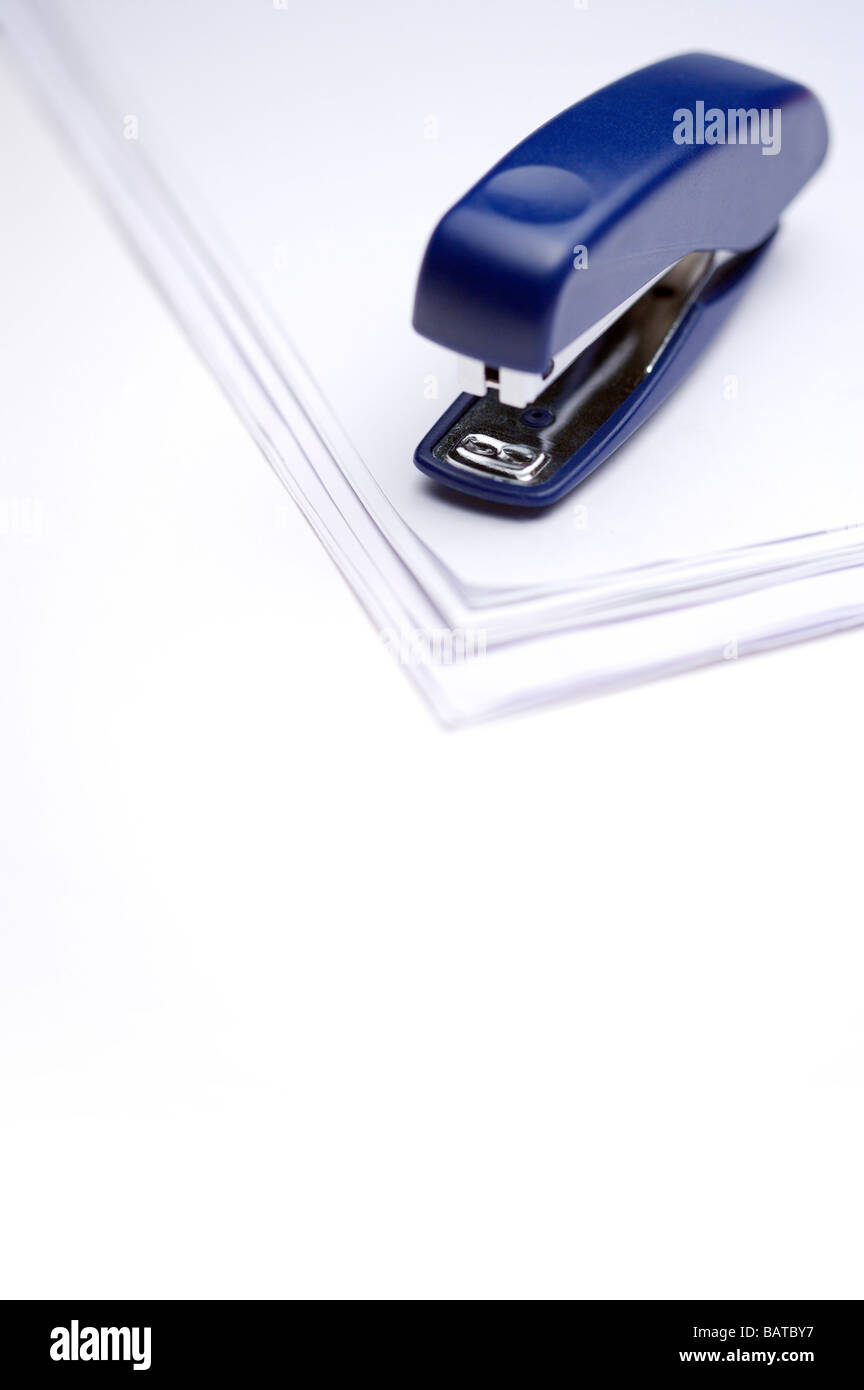 Stapler and stack of paper Stock Photo - Alamy