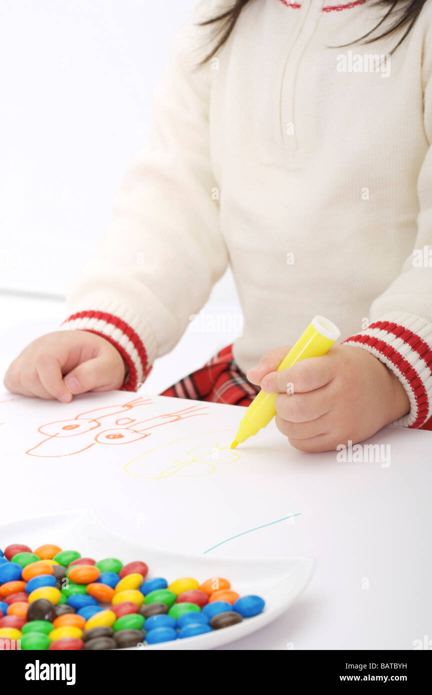 Girl drawing on paper Stock Photo - Alamy