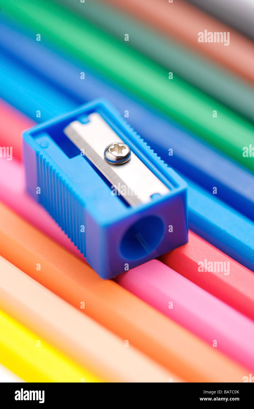 Colored pencils and pencil sharpener Stock Photo - Alamy