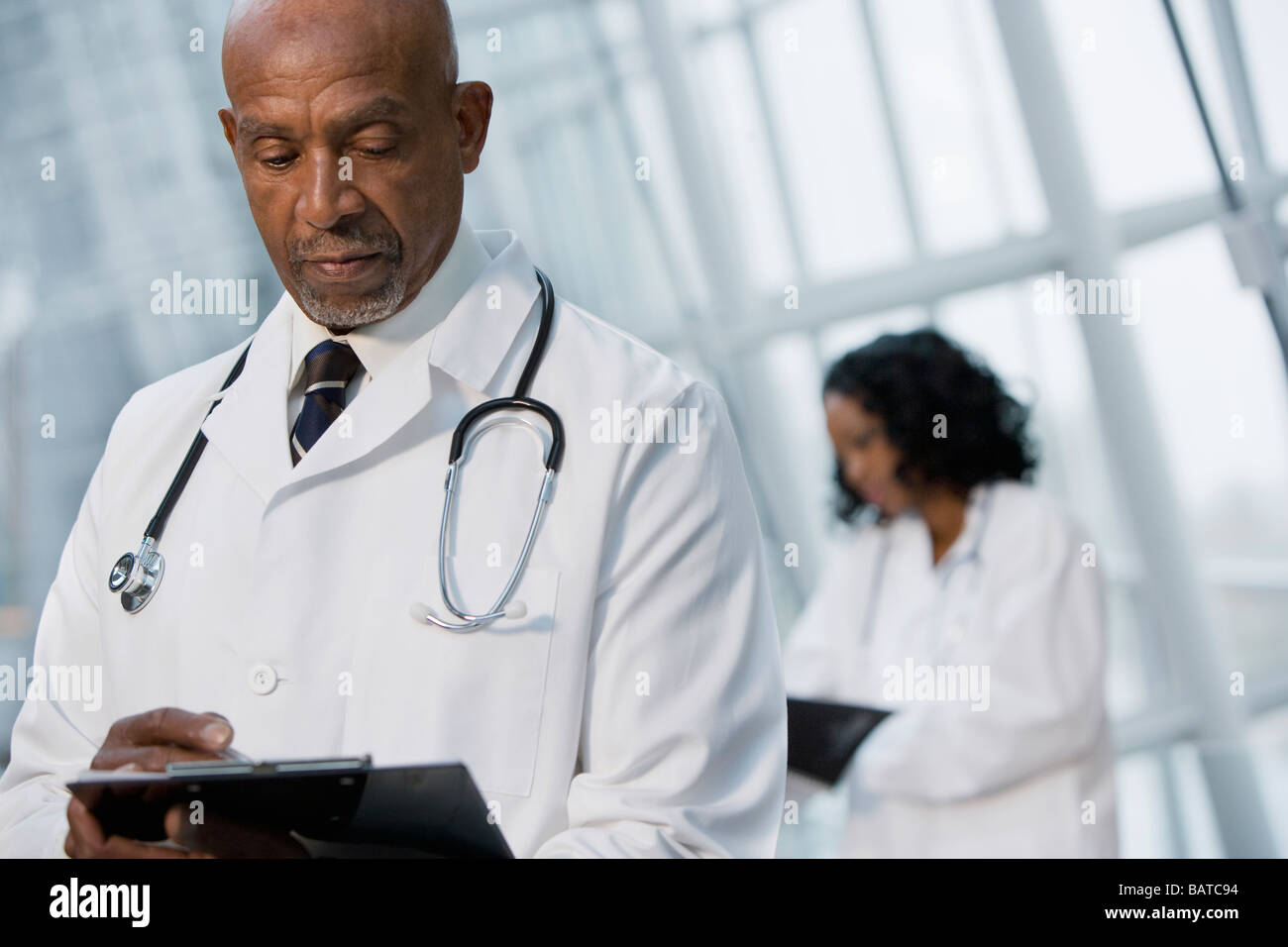 African doctor reviewing medical chart Stock Photo - Alamy