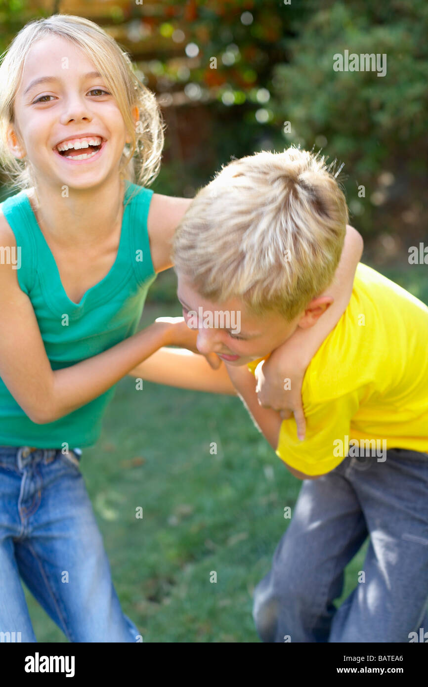 Children playing in the garden.The boy is six and the girl is eight ...