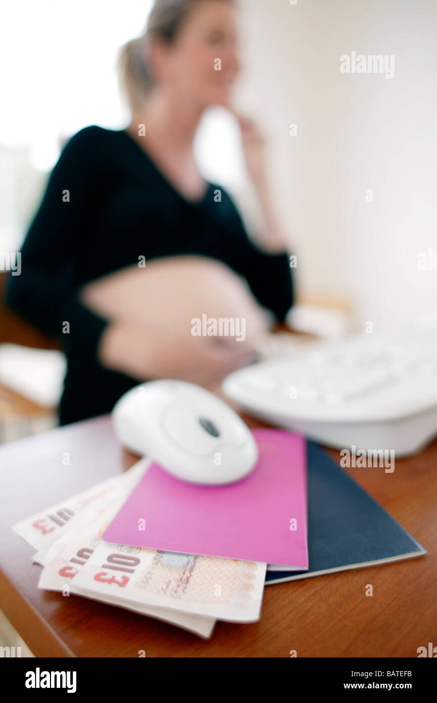 Pregnant woman working ata computer. She is in her third trimester ...