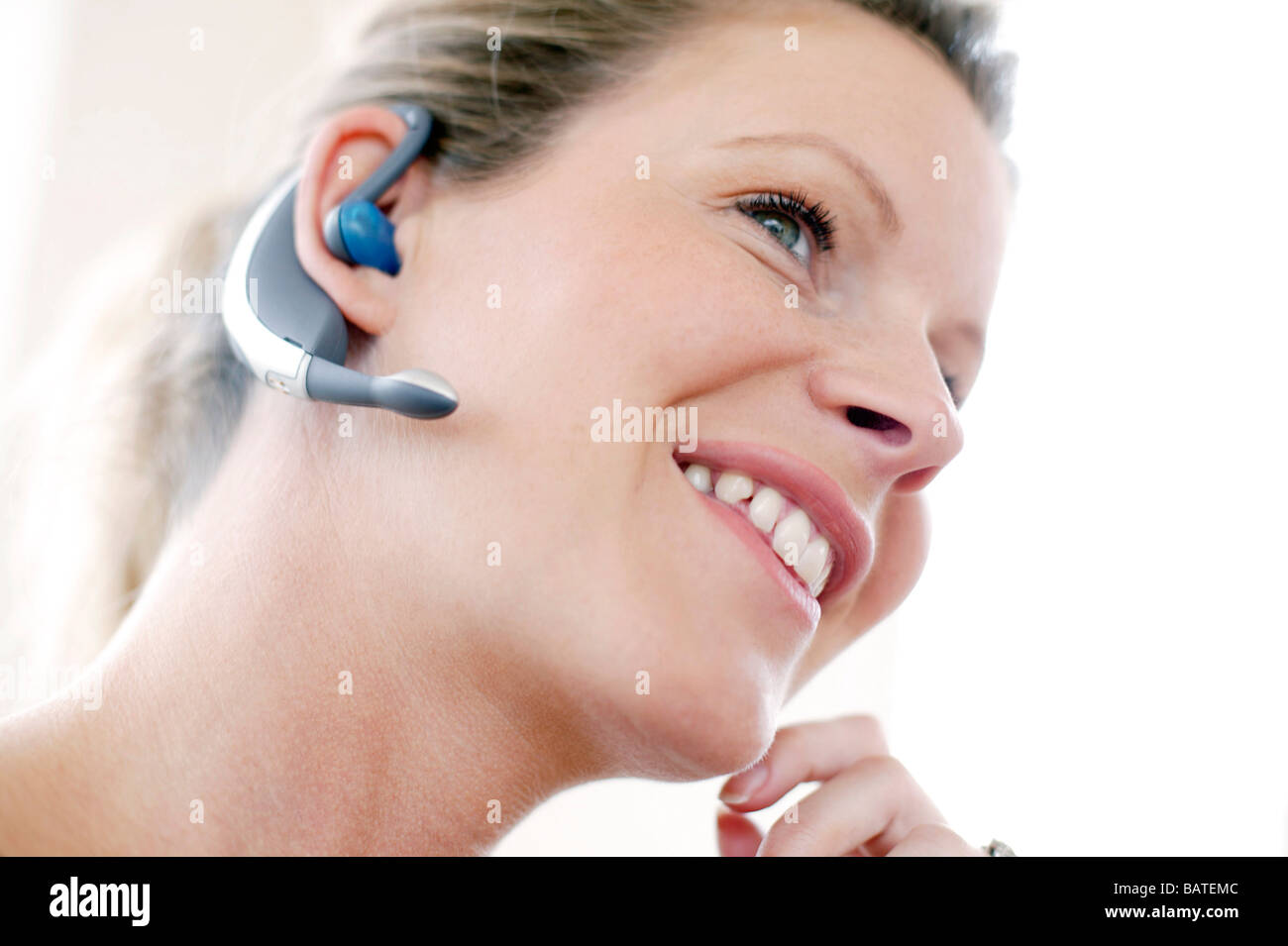 Wireless communication. Woman wearing a mobile phone headset Stock ...
