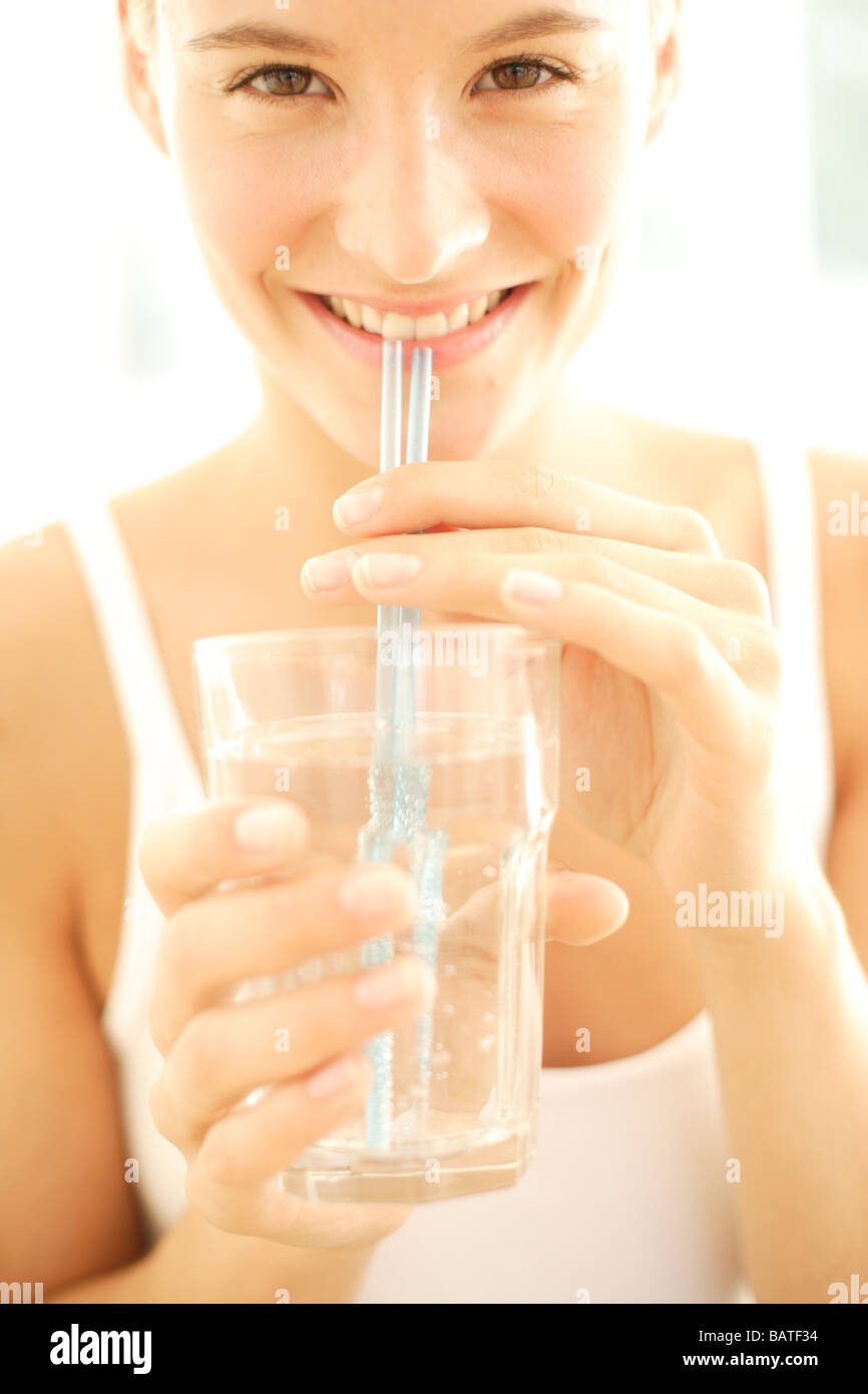 Woman drinking water through straw hi-res stock photography and images ...