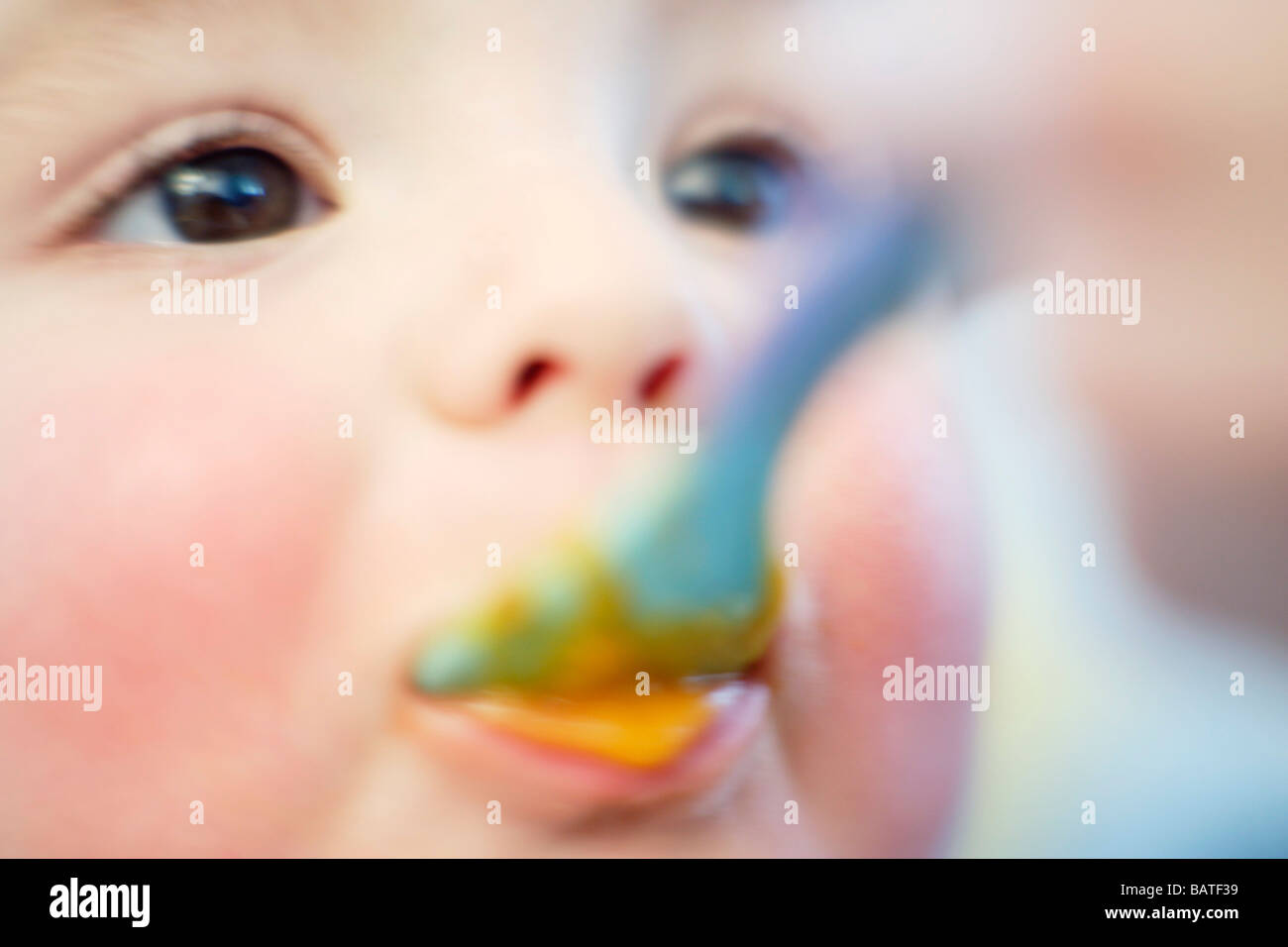 Spoon-feeding. Nine month old boy being spoon-fed Stock Photo - Alamy