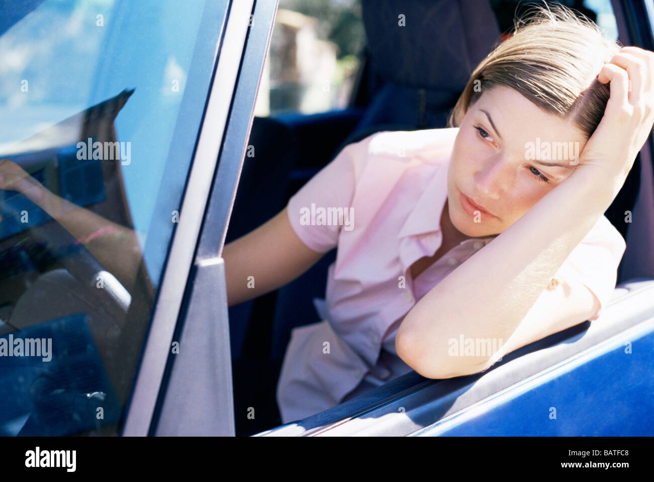 Frustrated driver leaning out of acar window Stock Photo - Alamy