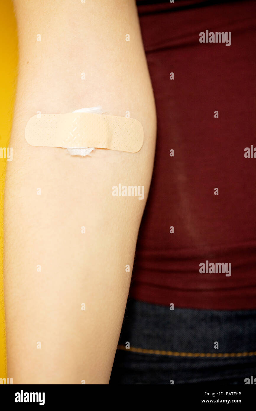 band-aid on a young woman's arm Stock Photo - Alamy