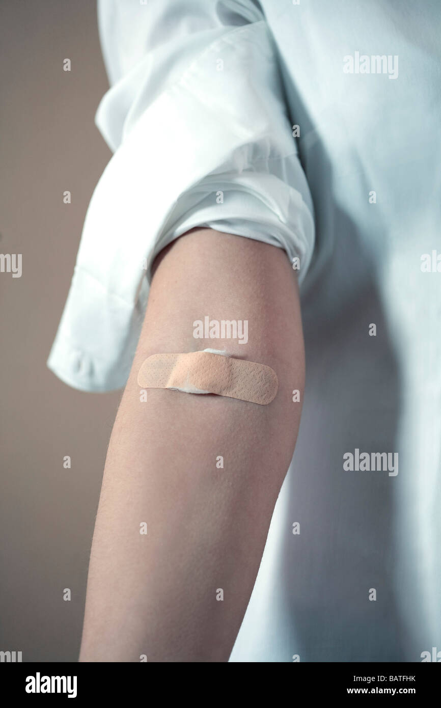 band-aid on a young woman's arm Stock Photo - Alamy