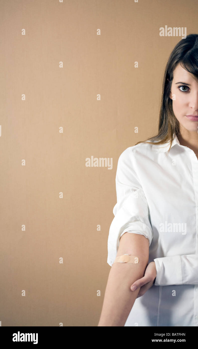 young woman with band-aid on arm Stock Photo - Alamy